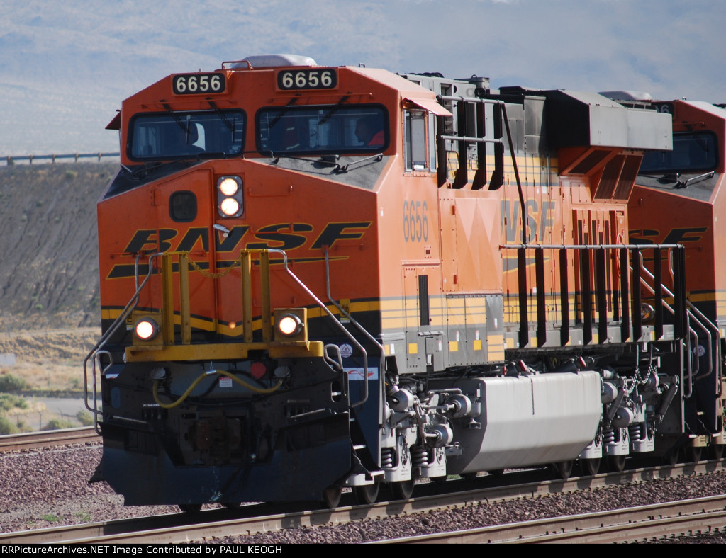 BNSF 6656 close in shot of the cab as the Engineer and Conductor talk to each other across the cab.